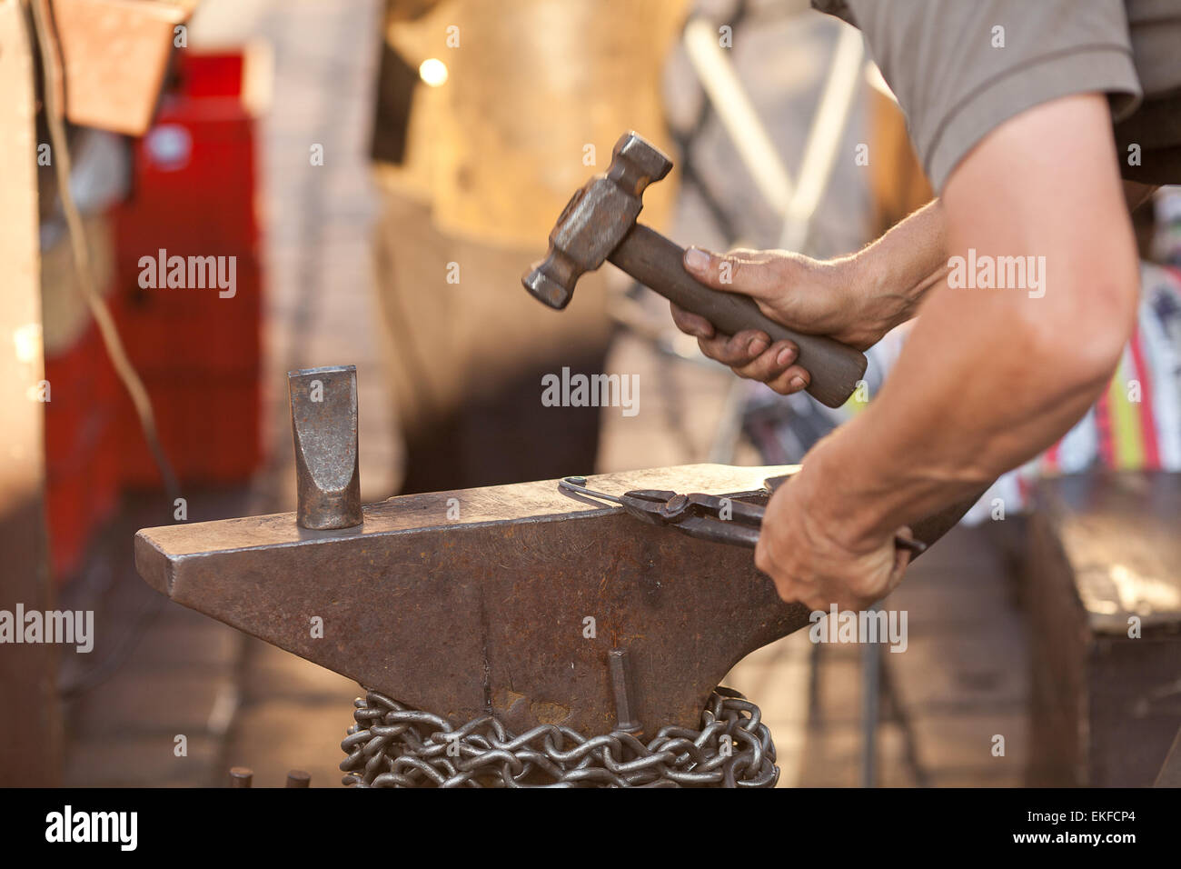 hammer, anvil and the hands of a blacksmith Stock Photo - Alamy