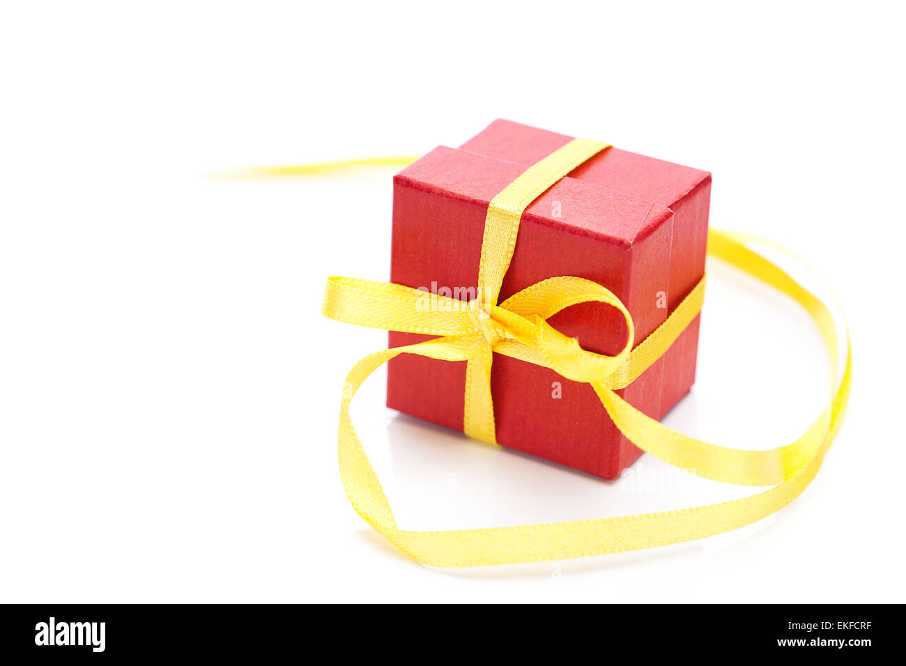 red gift box with a yellow ribbon isolated on white Stock Photo - Alamy