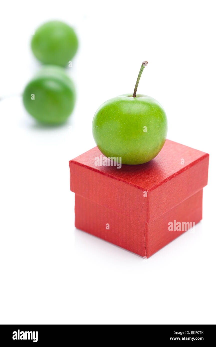 red gift box and green plum isolated on white Stock Photo - Alamy