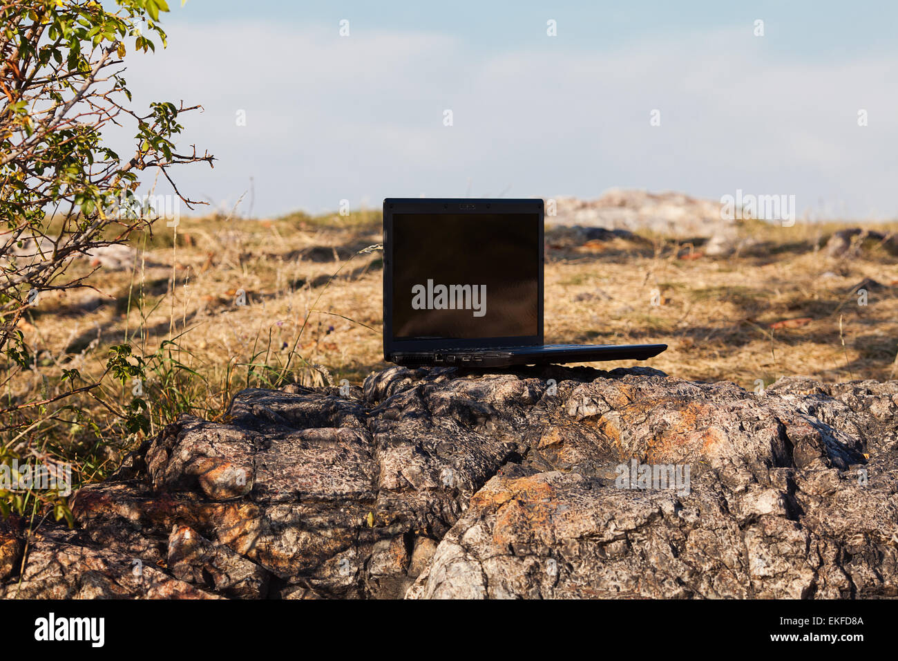 laptop stands on a rock against the blue sky Stock Photo - Alamy