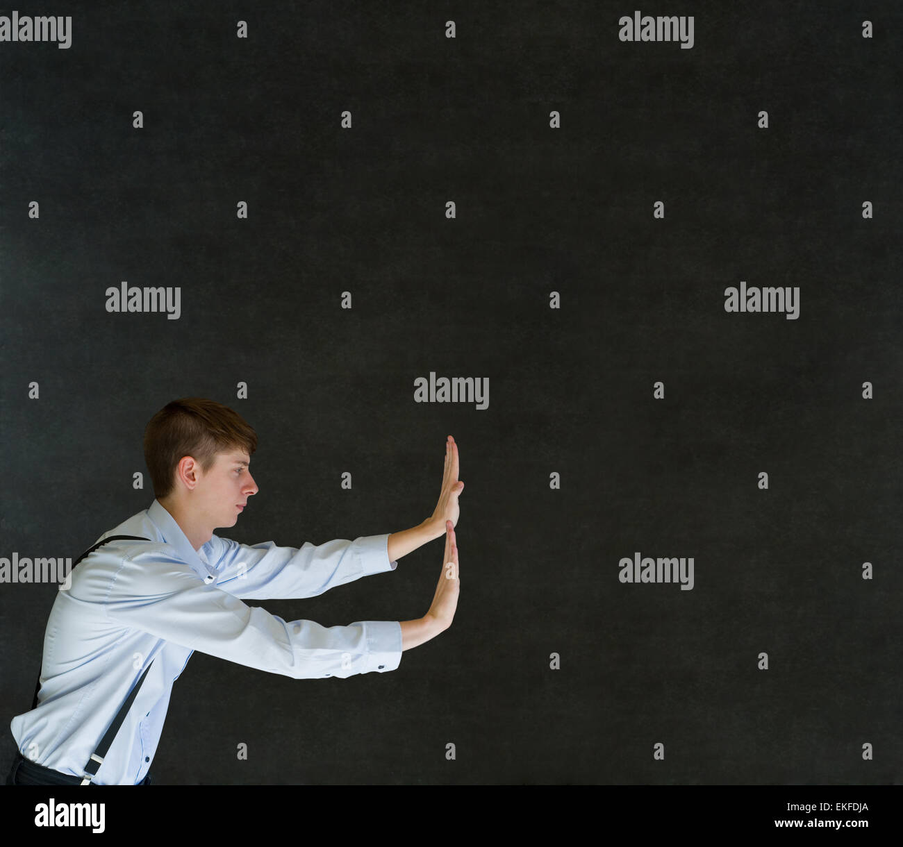 Man pushing on blackboard background Stock Photo - Alamy