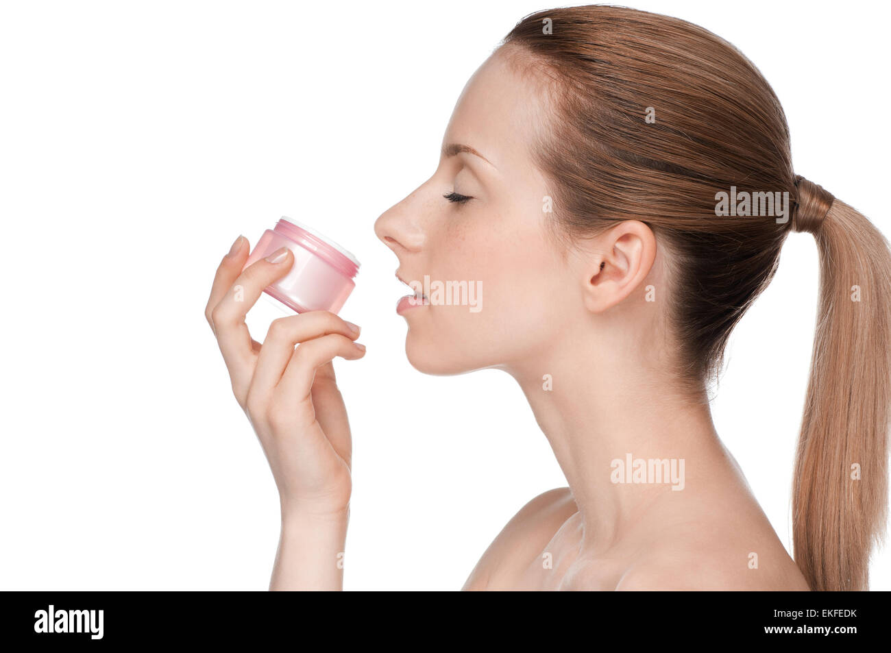 Young beautiful girl applying cream Stock Photo - Alamy