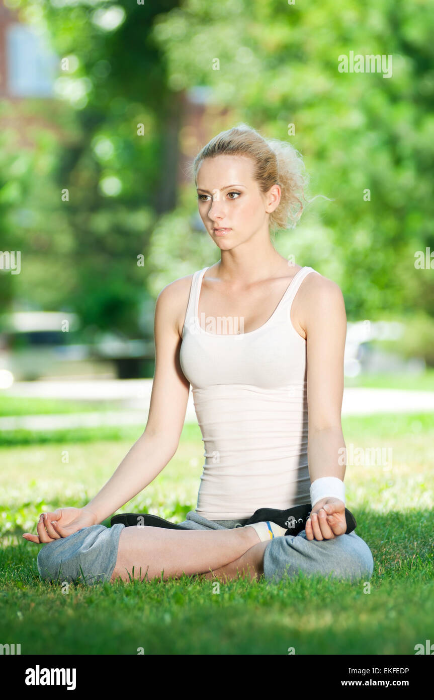 Young woman doing yoga exercise Stock Photo - Alamy