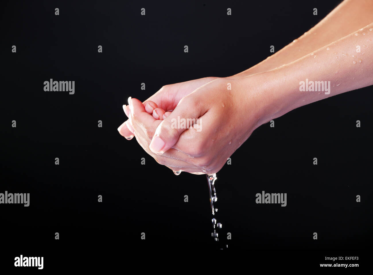 Water falling over hand hi-res stock photography and images - Alamy