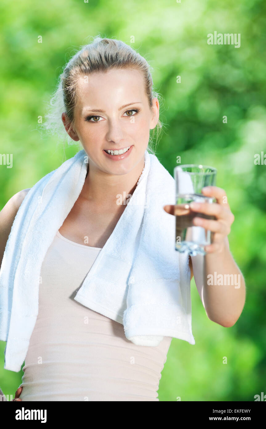 Woman drinking water after exercise Stock Photo - Alamy