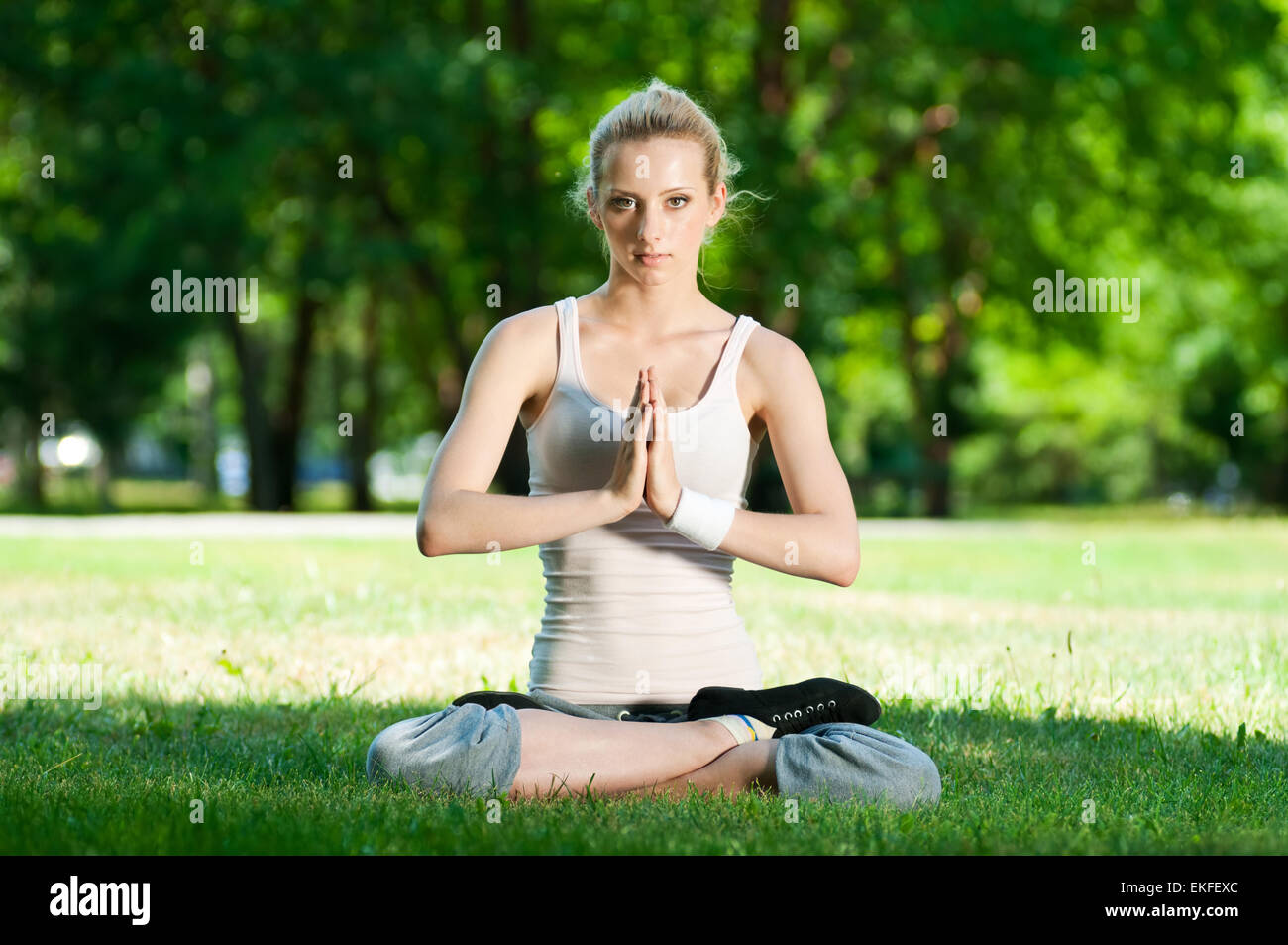 Young woman doing yoga exercise Stock Photo - Alamy