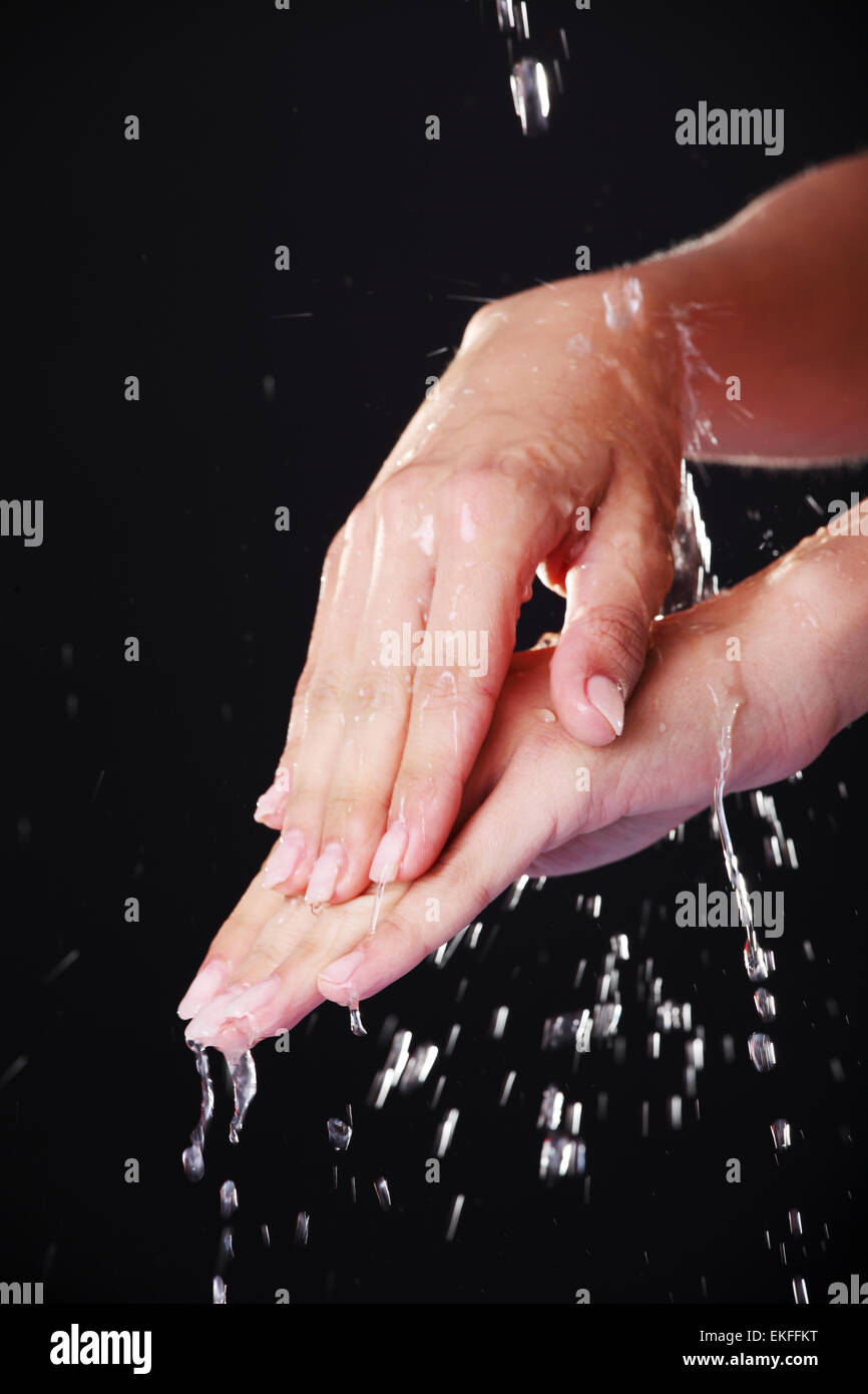 Water falling on female hands Stock Photo - Alamy
