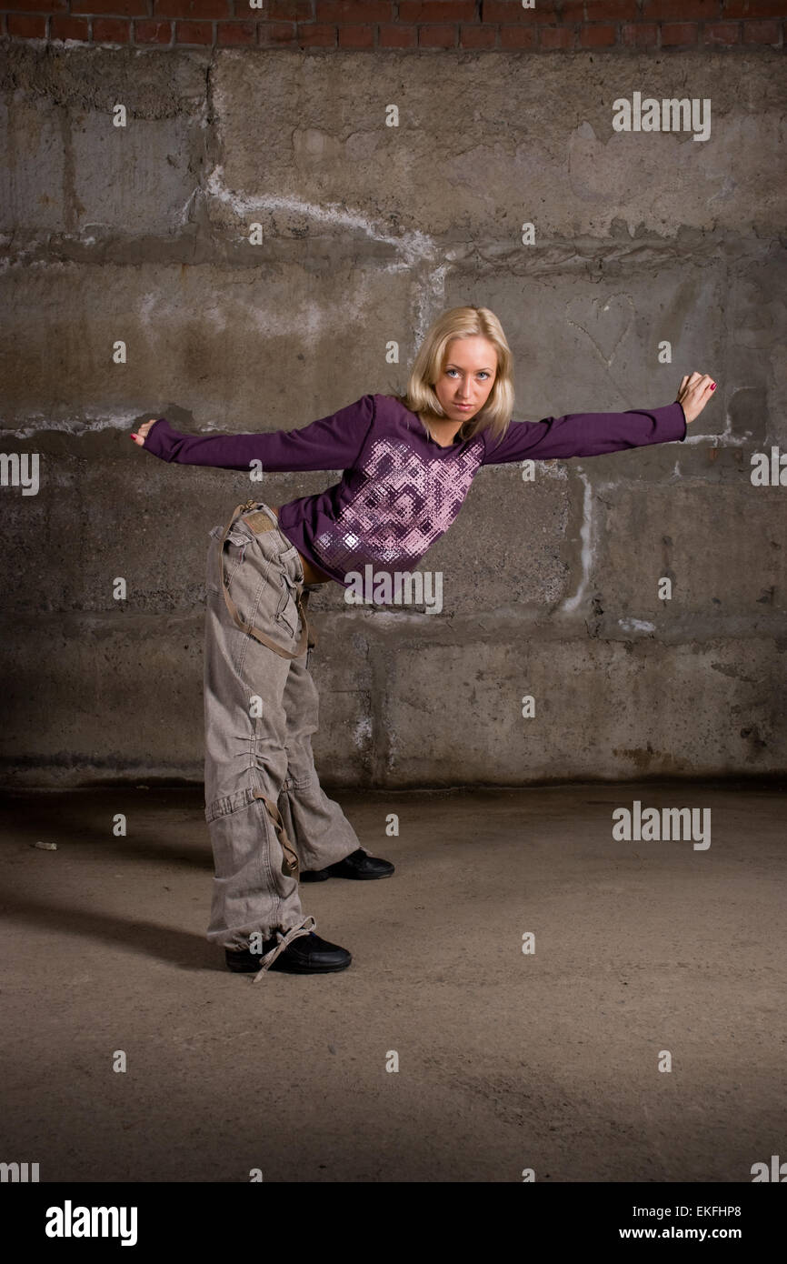 Beautiful hip hop girl dancing over grey brick wall Stock Photo - Alamy
