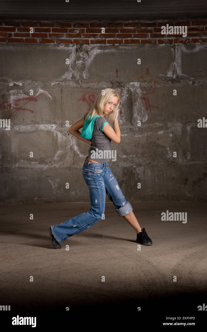 Beautiful hip hop girl dancing over grey brick wall Stock Photo - Alamy