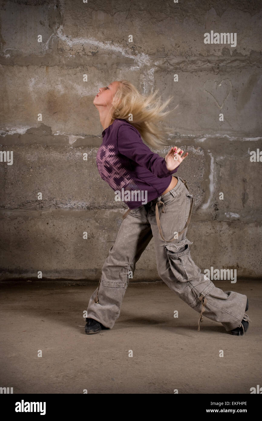 Beautiful hip hop girl dancing over grey brick wall Stock Photo - Alamy