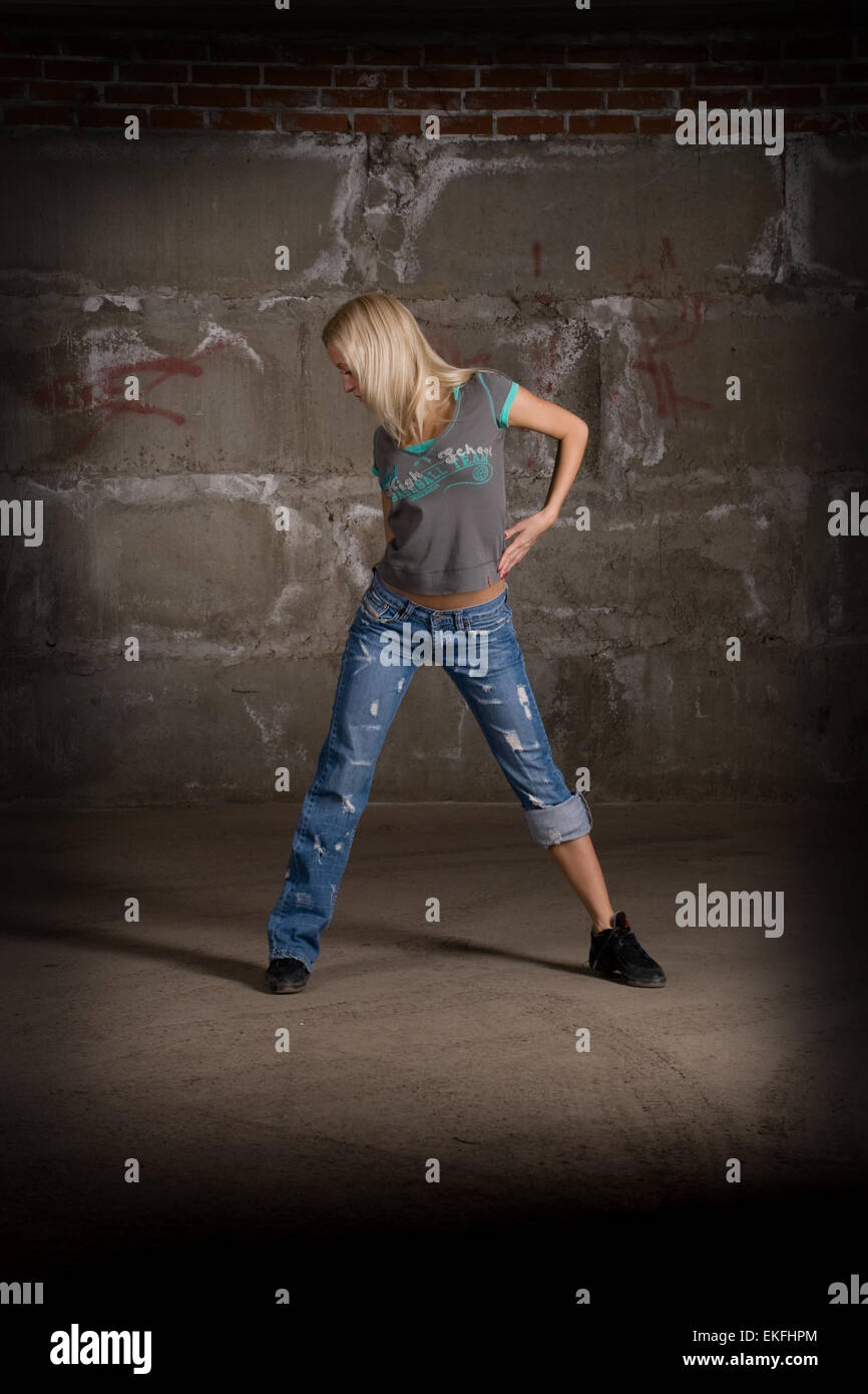Beautiful hip hop girl dancing over grey brick wall Stock Photo - Alamy