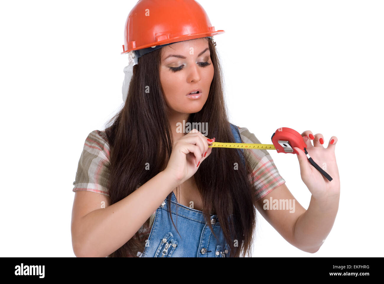 Young woman in orange helmet holding tape measure Stock Photo - Alamy