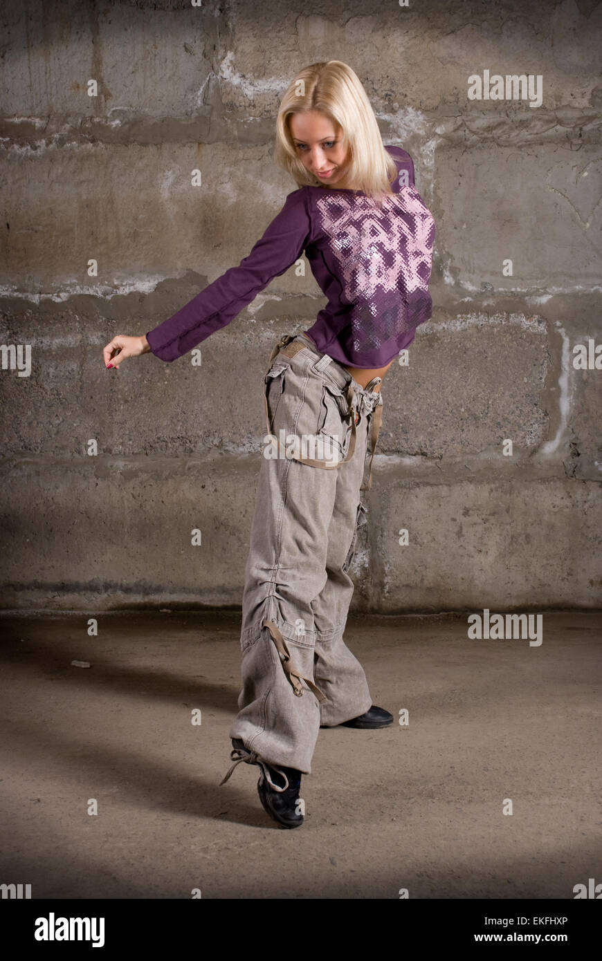 Beautiful hip hop girl dancing over grey brick wall Stock Photo - Alamy