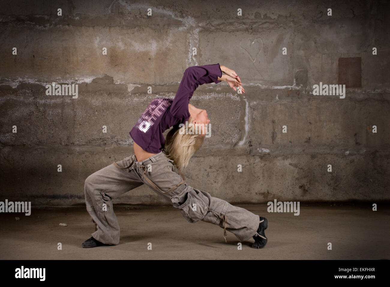 Beautiful hip hop girl dancing over grey brick wall Stock Photo - Alamy
