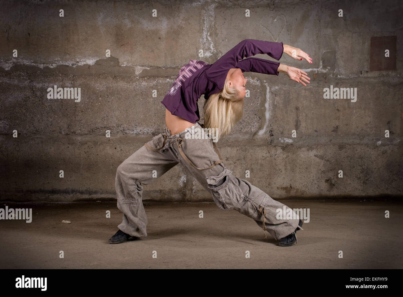 Beautiful hip hop girl dancing over grey brick wall Stock Photo - Alamy