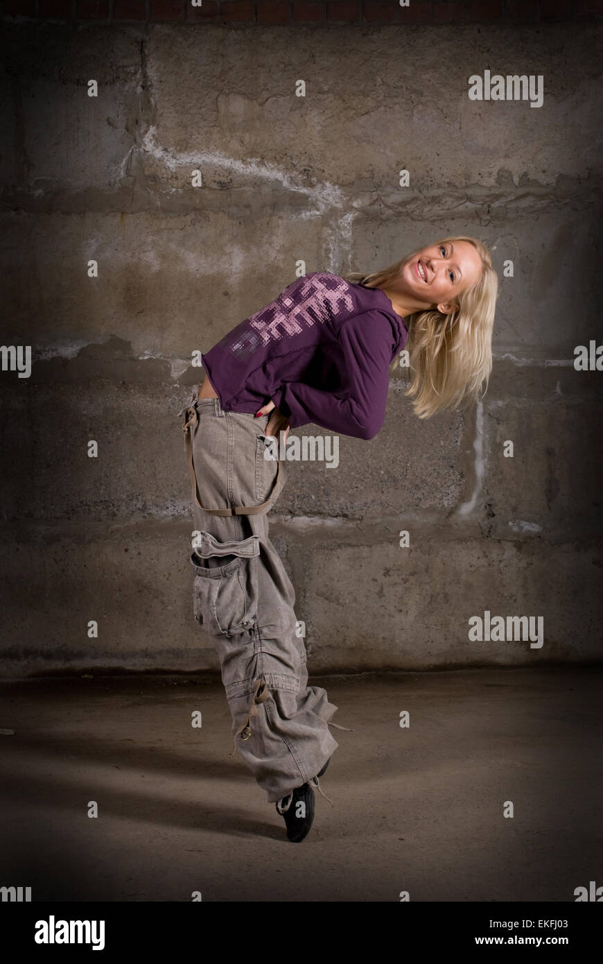 Beautiful hip hop girl dancing over grey brick wall Stock Photo - Alamy
