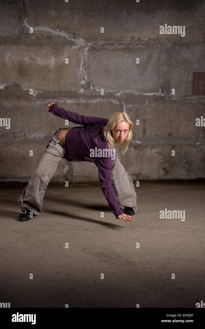 Beautiful hip hop girl dancing over grey brick wall Stock Photo - Alamy