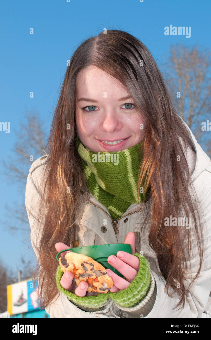 Girl on winter picnic with cup of tee and cookies Stock Photo - Alamy