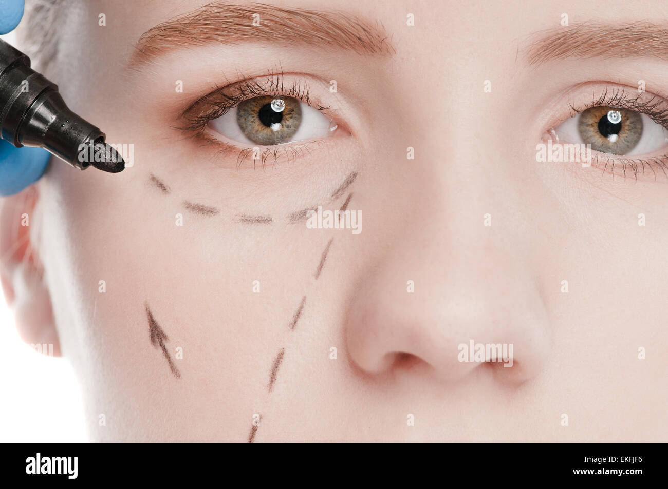 Beautician draw correction lines on woman face Stock Photo - Alamy