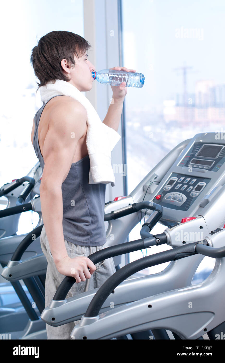 man at the gym drinking water Stock Photo - Alamy