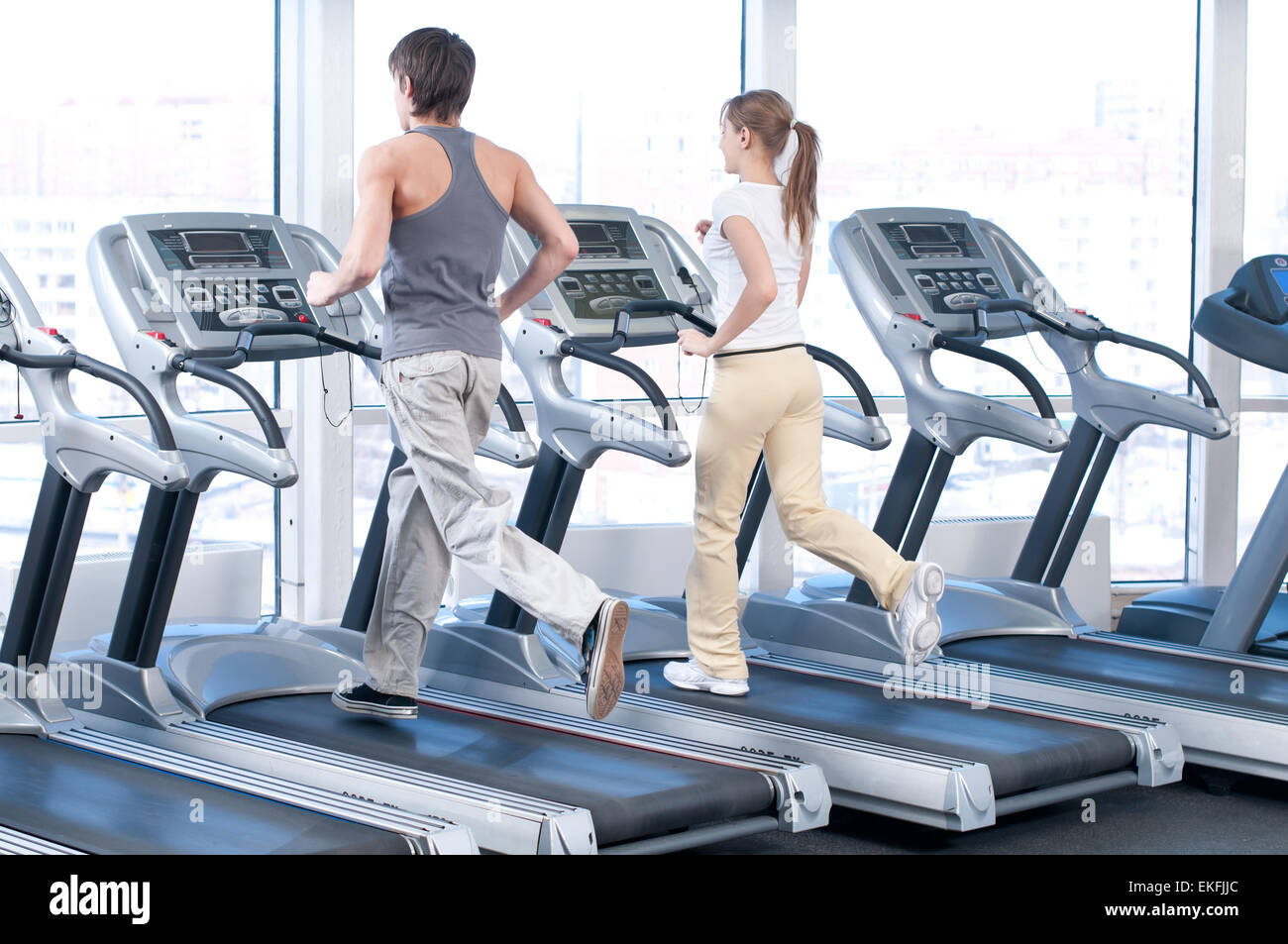 Young woman and man at the gym exercising. Running Stock Photo - Alamy