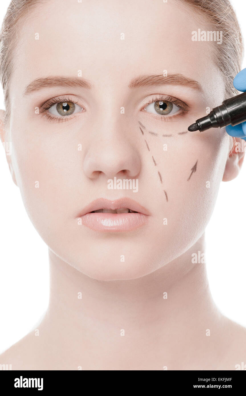 Beautician draw correction lines on woman face Stock Photo - Alamy
