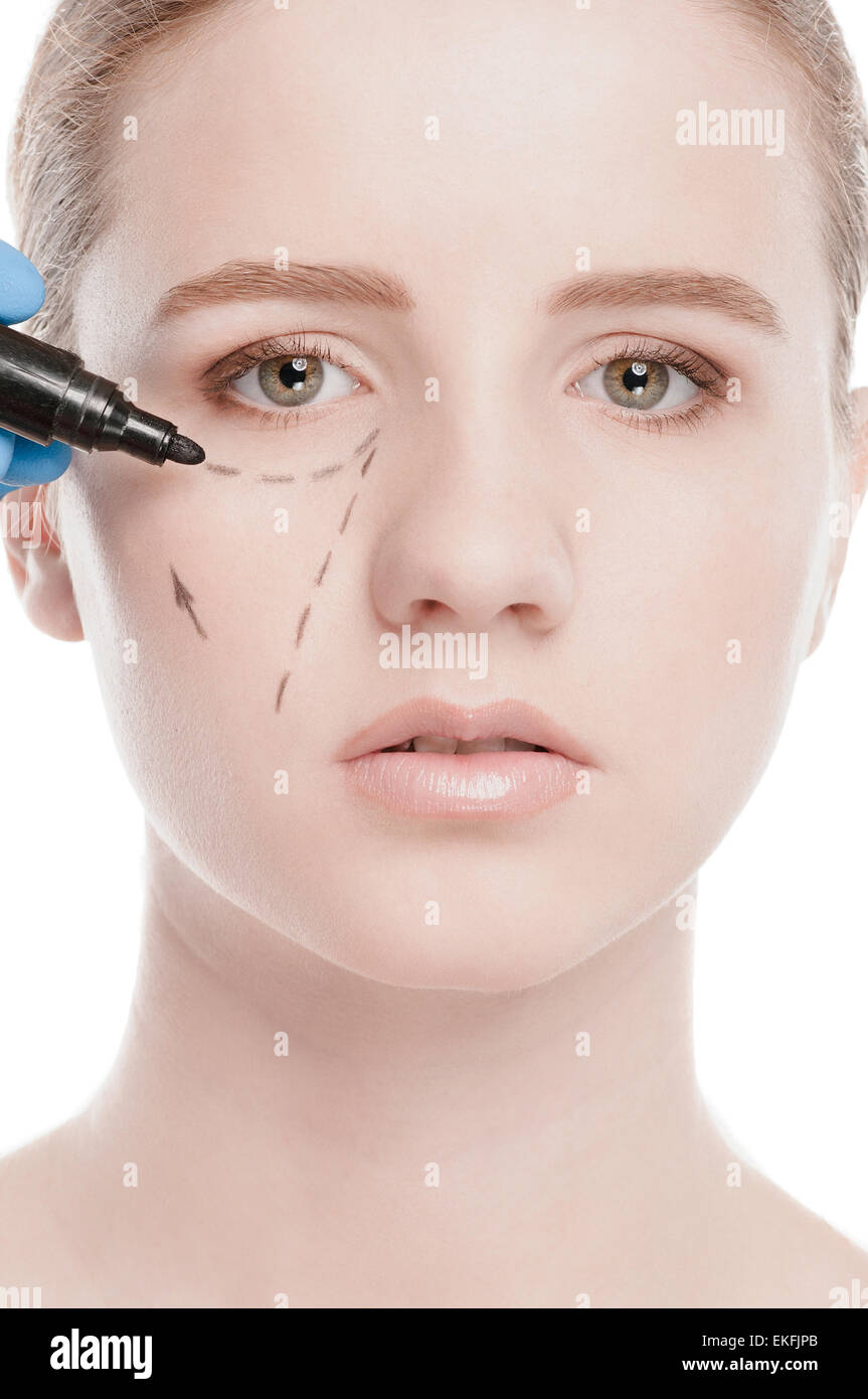 Beautician draw correction lines on woman face Stock Photo - Alamy