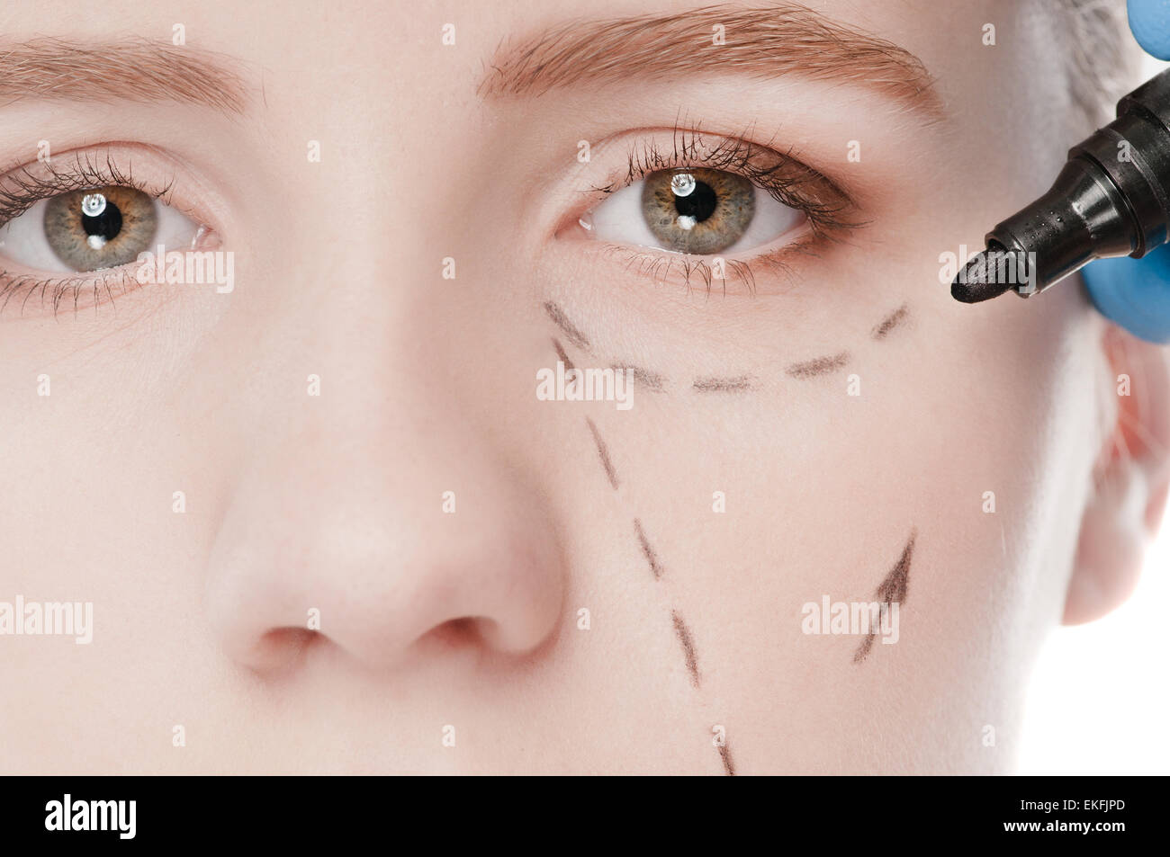 Beautician draw correction lines on woman face Stock Photo - Alamy