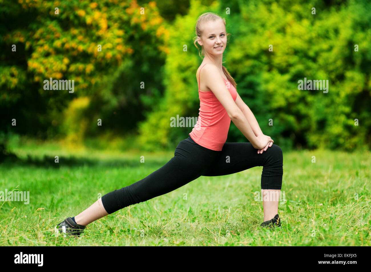 Young woman doing stretching exercise Stock Photo - Alamy