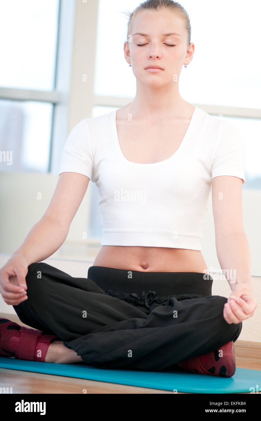 Young woman doing yoga exercises Stock Photo - Alamy