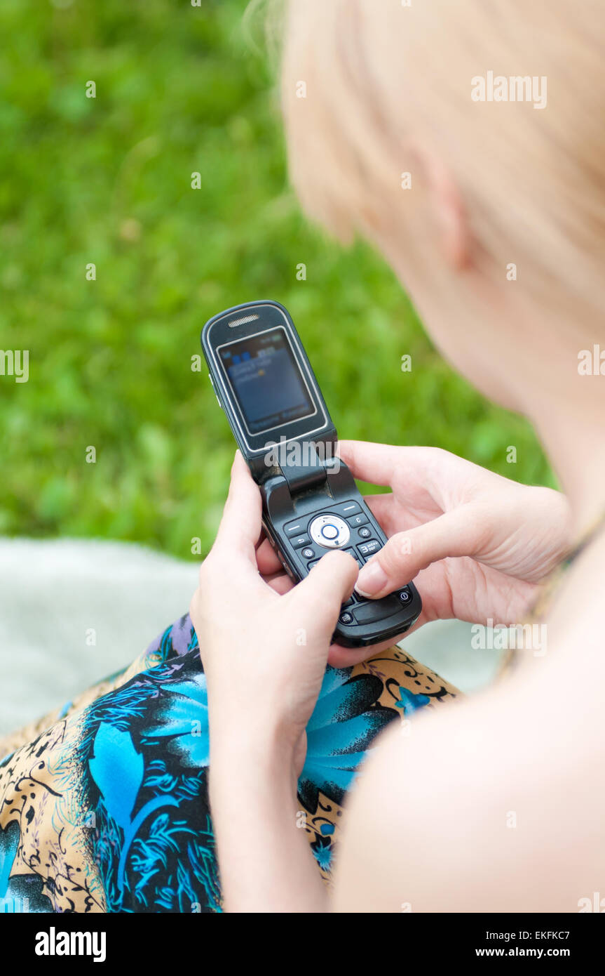 Woman texting on mobile phone Stock Photo - Alamy
