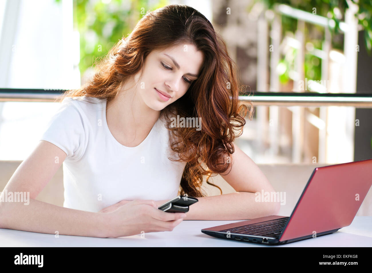 A young business woman sitting in a cafe Stock Photo - Alamy