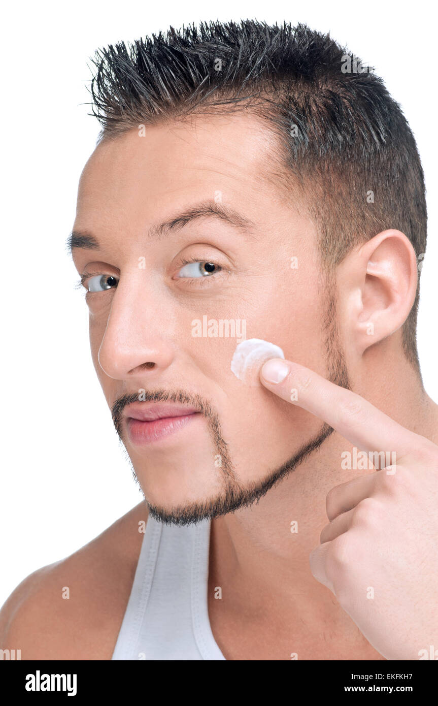 Handsome man applying male creme on face Stock Photo - Alamy