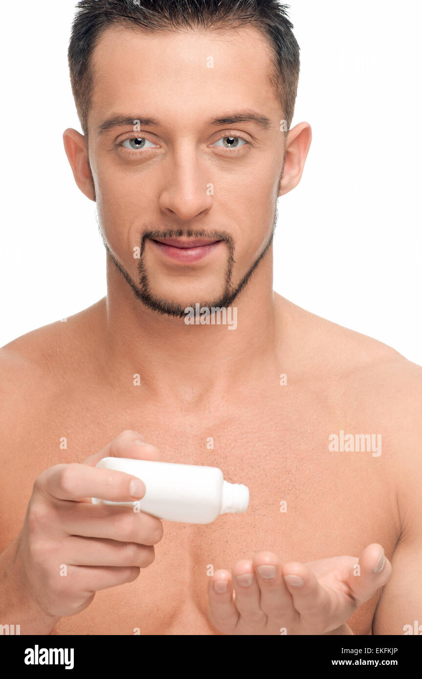 Young man applying cream. Cosmetic Stock Photo - Alamy