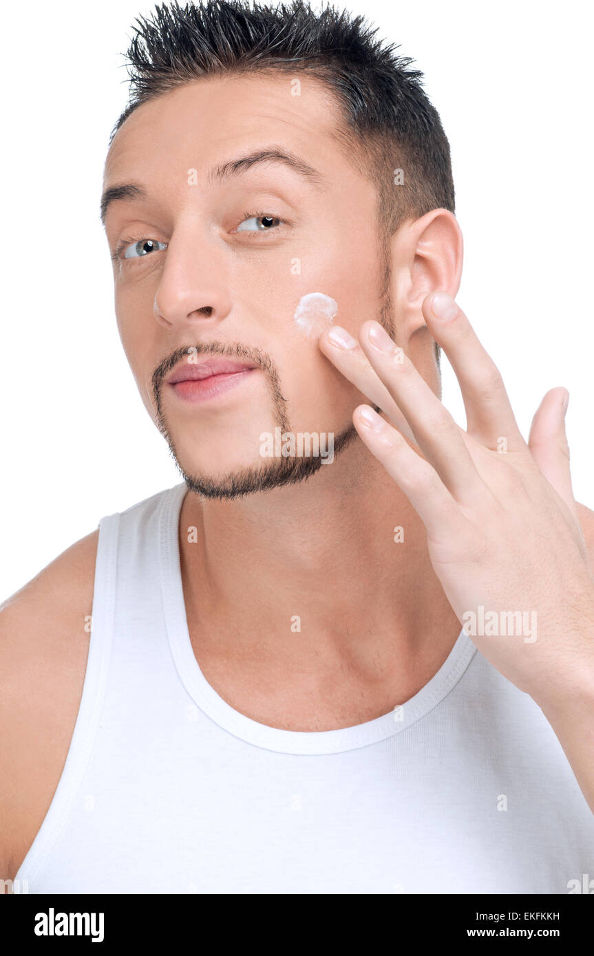 Handsome man applying male creme on face Stock Photo - Alamy