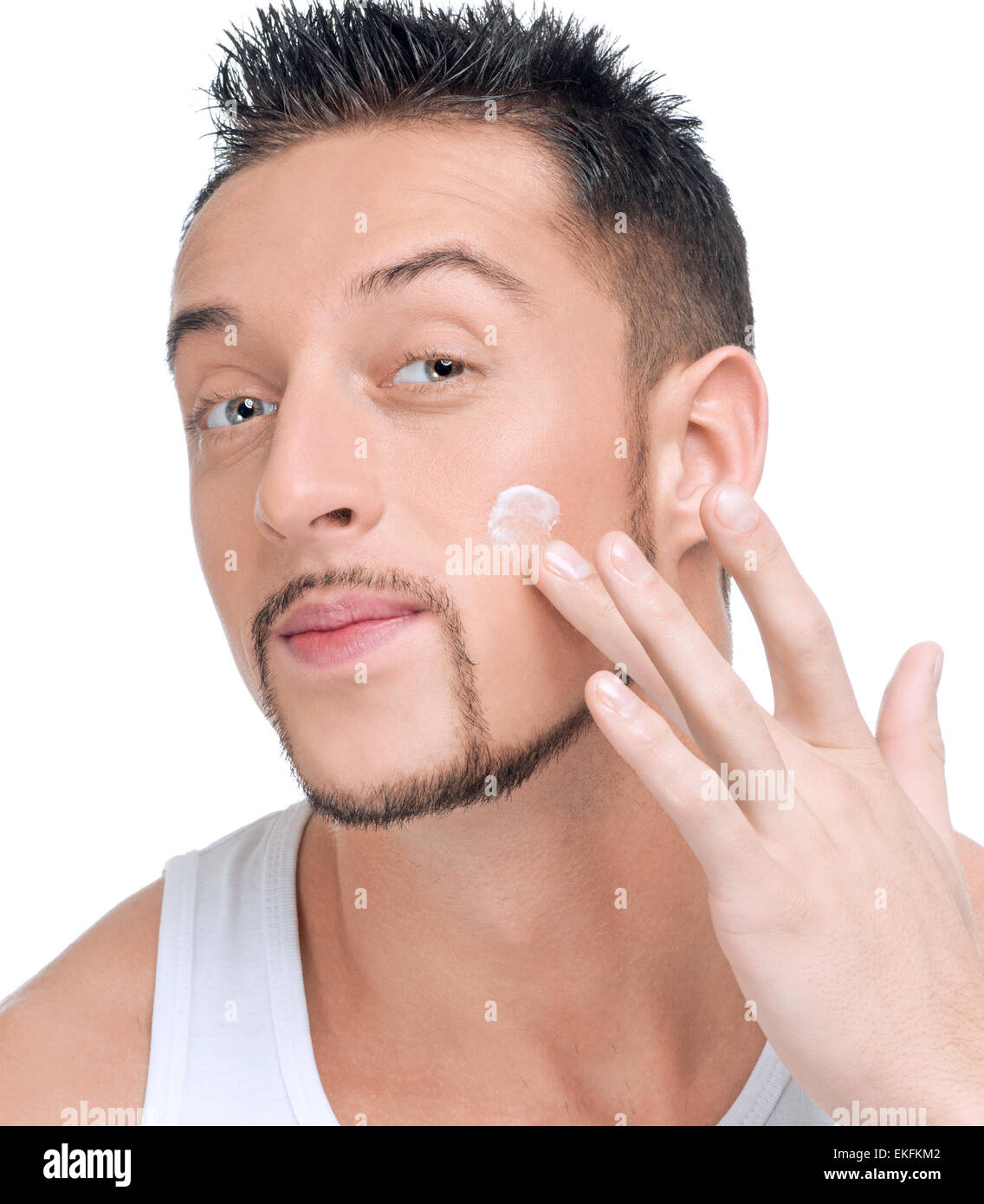 Handsome man applying male creme on face Stock Photo - Alamy