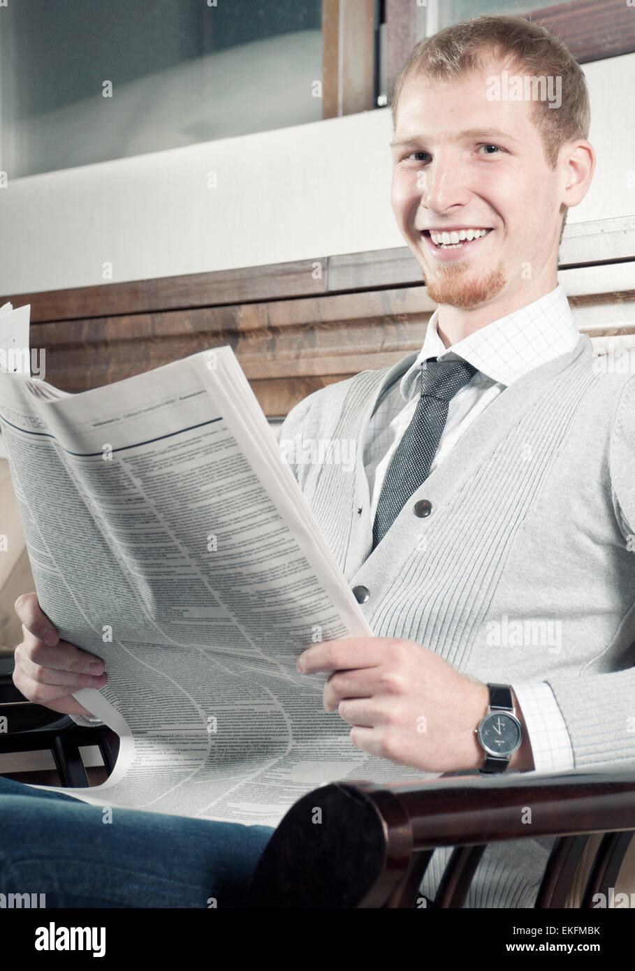Sure young business man with newspaper Stock Photo - Alamy