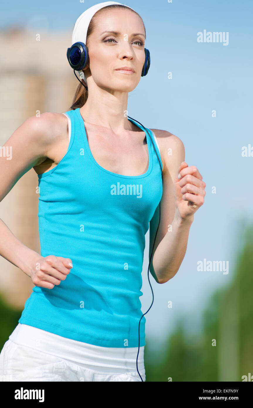 Beautiful woman running in green park Stock Photo - Alamy