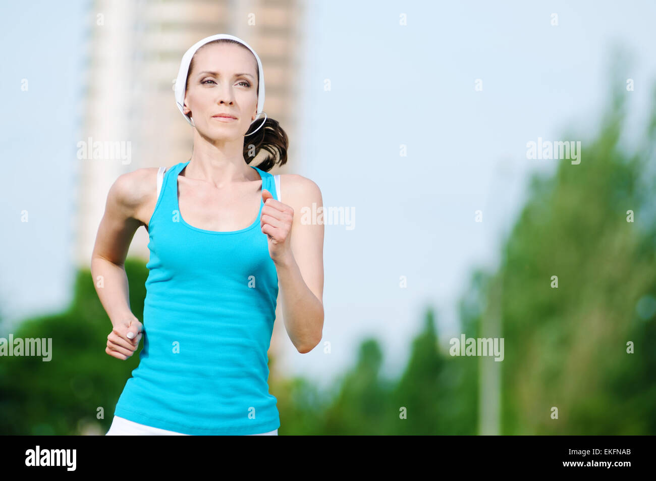 Beautiful woman running in green park Stock Photo - Alamy