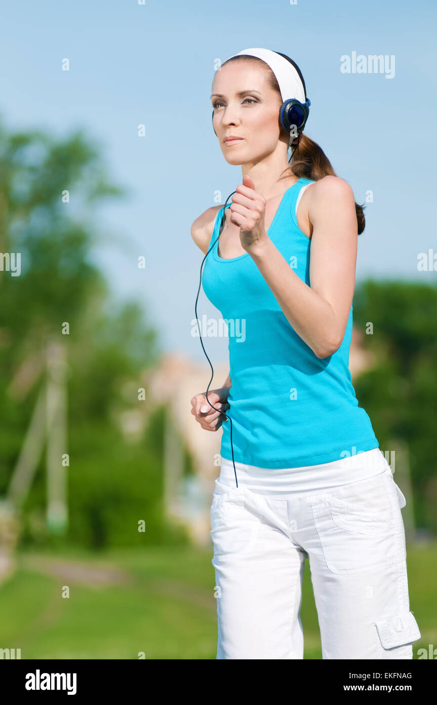 Sportive woman jogging in green hi-res stock photography and images - Alamy