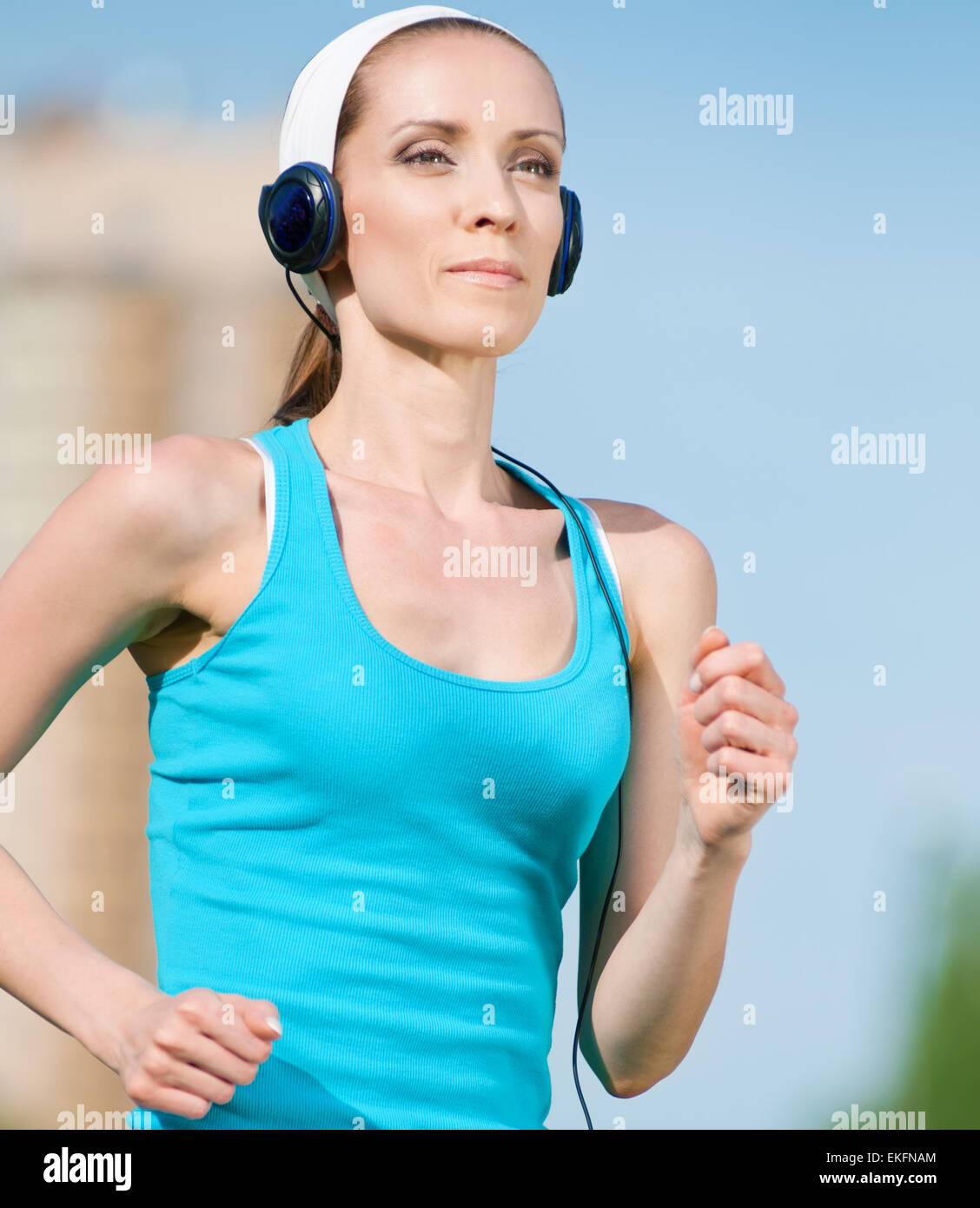 Beautiful woman running in green park Stock Photo - Alamy