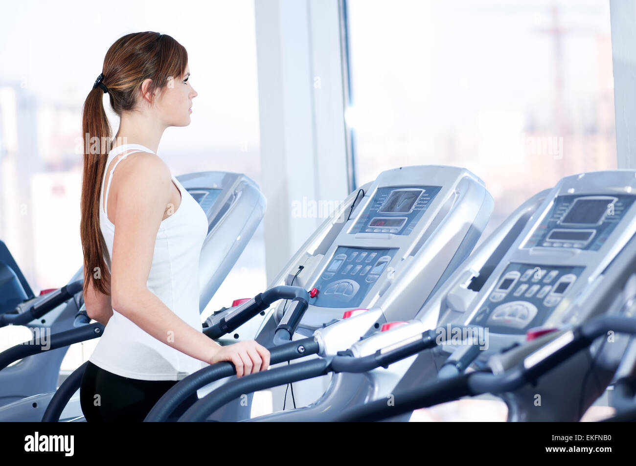 Young woman at the run at gym Stock Photo - Alamy