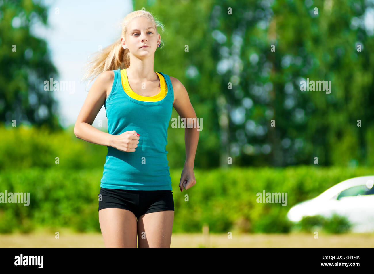 Young woman running in green park Stock Photo - Alamy