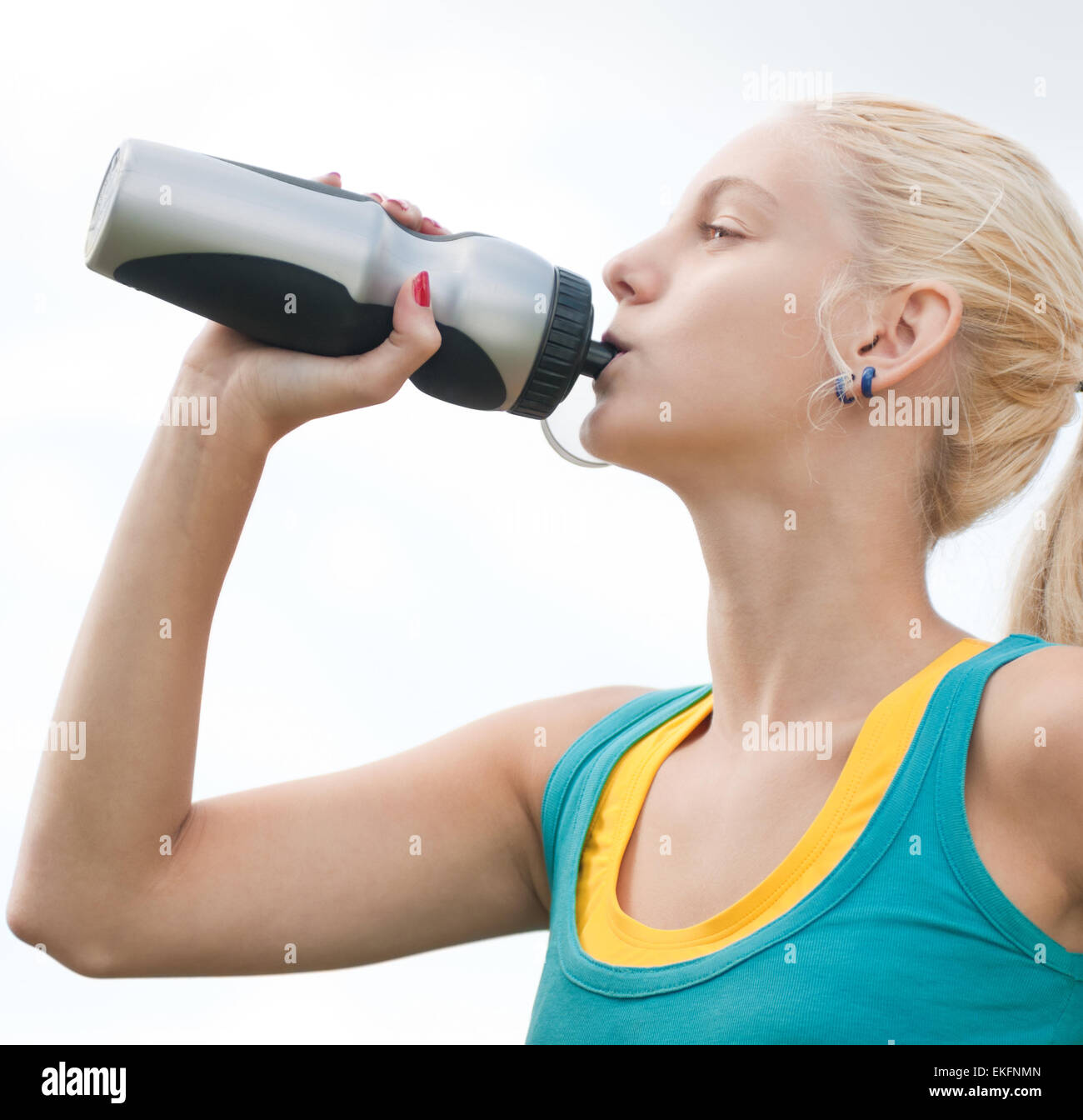 Woman drinking water after exercise Stock Photo - Alamy