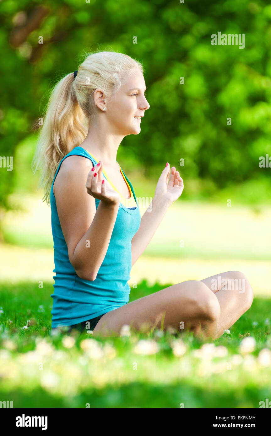 Young woman doing yoga exercise Stock Photo - Alamy