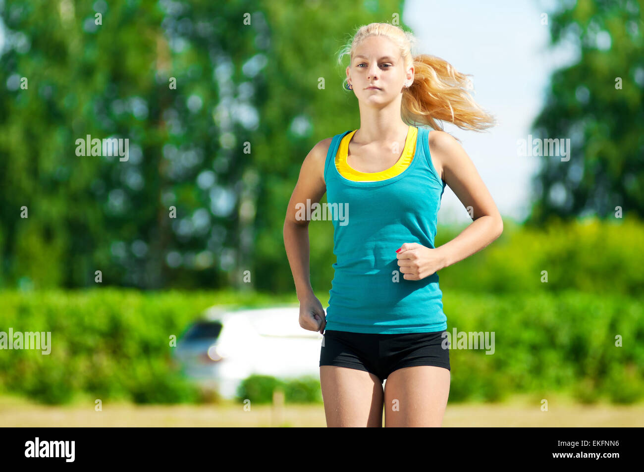 Young woman running in green park Stock Photo - Alamy