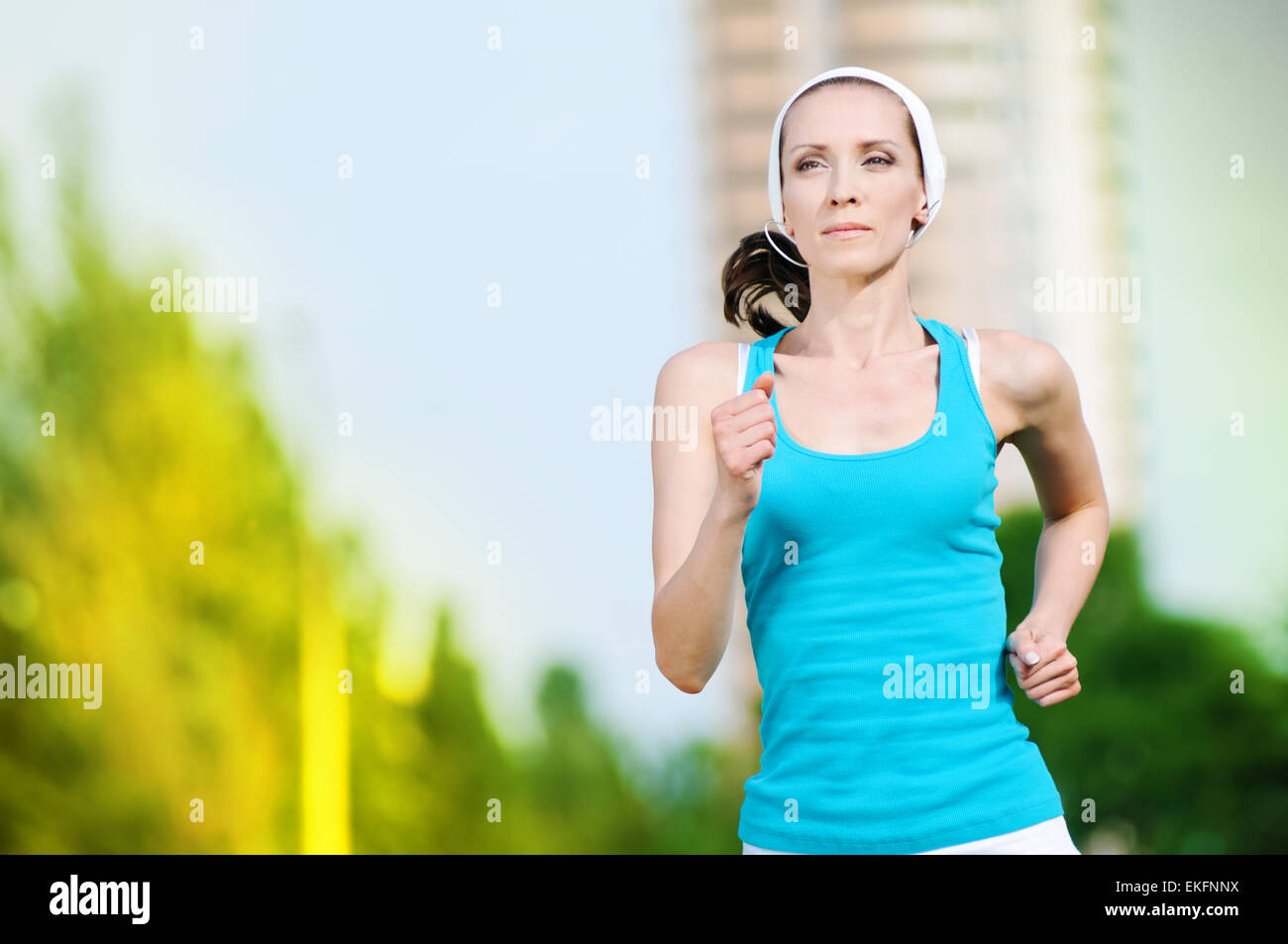 Beautiful woman running in green park Stock Photo - Alamy