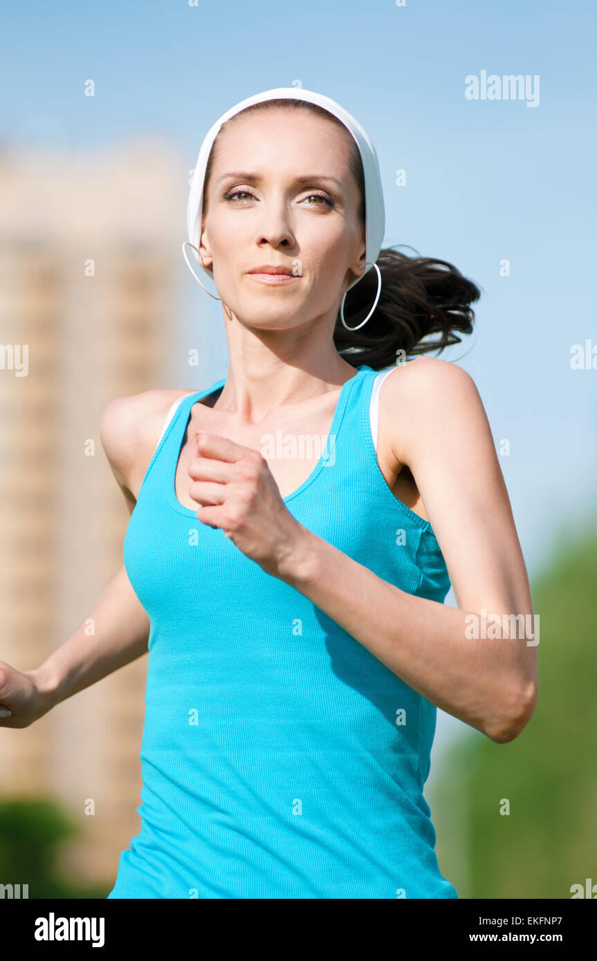 Beautiful woman running in green park Stock Photo - Alamy
