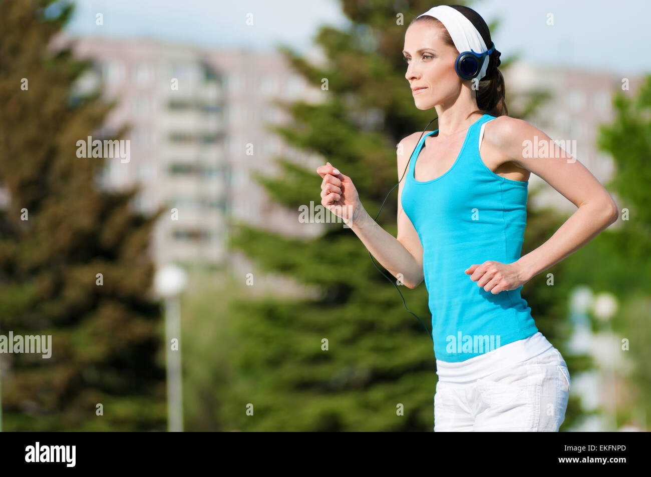 Beautiful woman running in green park Stock Photo - Alamy