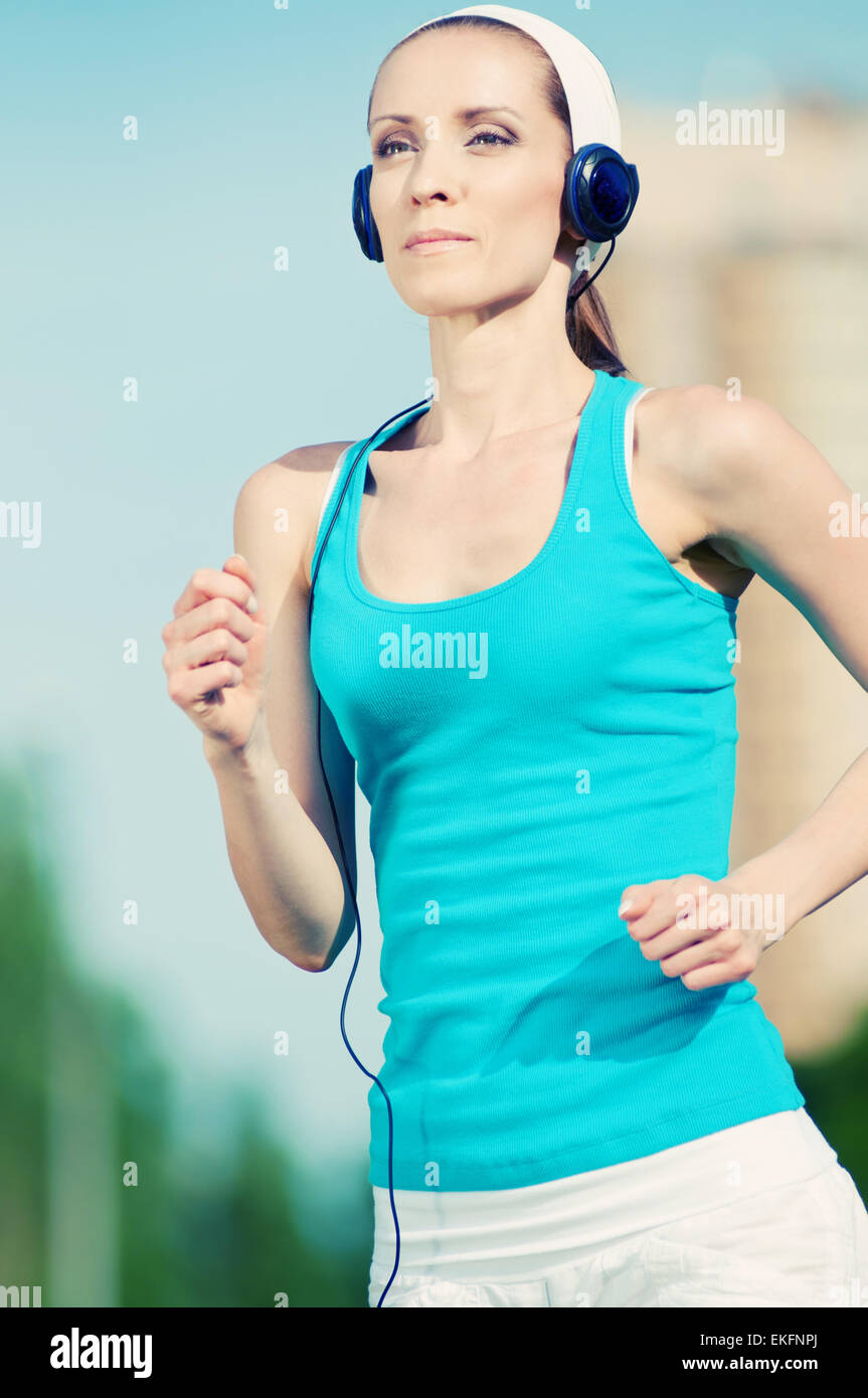 Beautiful woman running in green park Stock Photo - Alamy